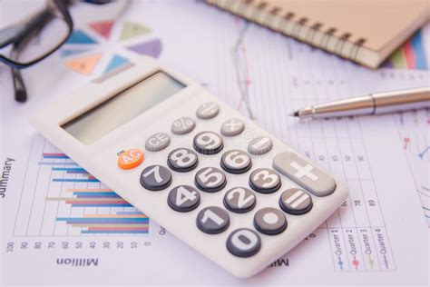 Data Analyzing With Calculator Notebook And Pen On Charts And Stock Image Image Of Economy