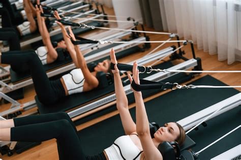 Premium Photo Lying Down In A Row And Doing Stretches Women In