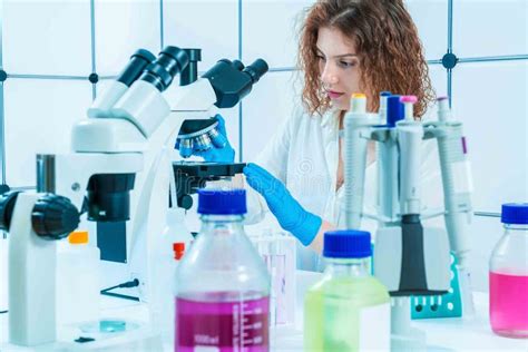 Young Woman In A Scientific Laboratory Working With A Microscope Stock Image Image Of