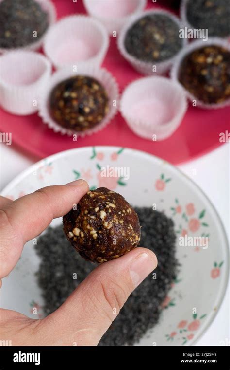 A Woman Is Holding A Dried Fruit Candy In Her Hand Balls Of Prunes