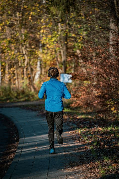 Monochrome Photography Of People Jogging Through The Woods · Free Stock