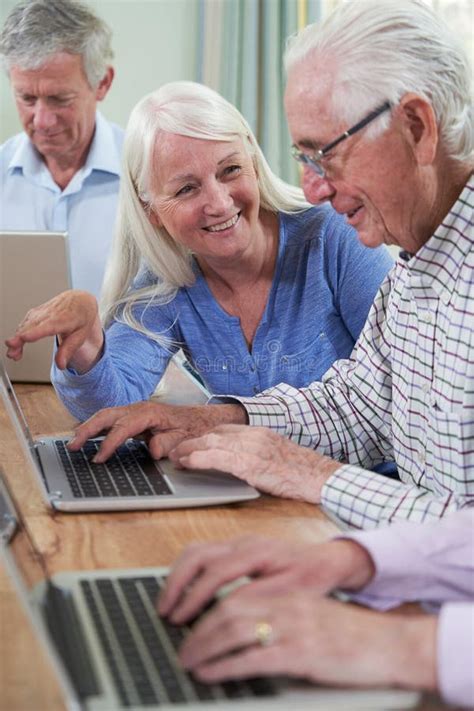 tutor helping senior man in computer class stock image image of