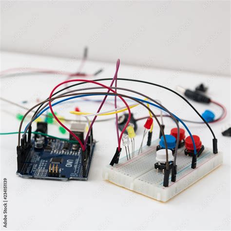 Foto De A Cute Girl Constructs Robot Arduino And Program It The Boards And Microcontrollers Are