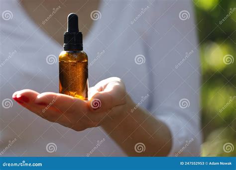 A Woman Presenting A Bottle With A Dropper On Her Hand Medicinal Product Stock Image Image Of