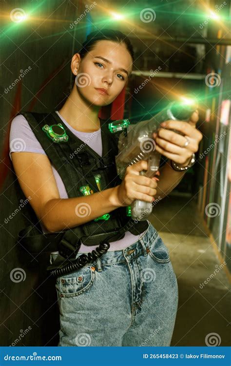 woman with laser guns took aim and posing during laser tag game stock