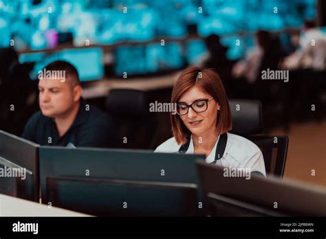 Female Security Operator Working In A Data System Control Room Offices Technical Operator