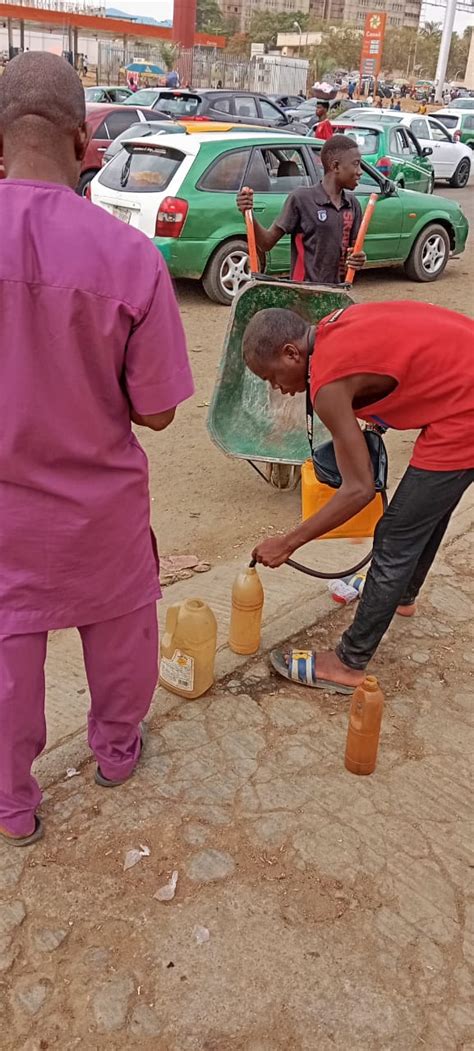 Photos Black Marketers Take Advantage Of Fuel Queues In Abuja Daily