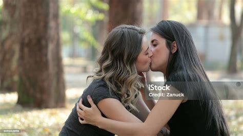 Lesbian Couple Kissing Each Other Outdoors At The Park Lgbt Women Stock