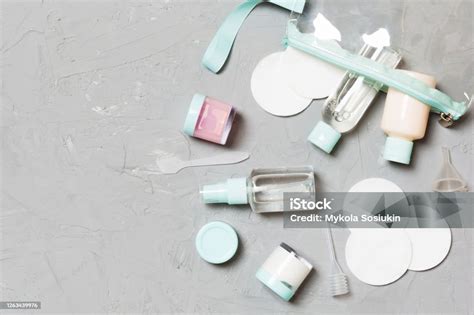 회색 배경으로 여행하기위한 작은 병 그룹 아이디어를 위한 공간을 복사합니다 화장품의 플랫 레이 조성 면 패드가 있는 크림 용기의