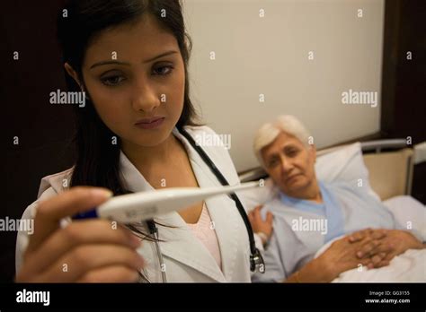 Doctor Taking Patient S Temperature Stock Photo Alamy