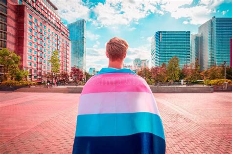 Runner Woman Holding Transgender Pride Flag While Walking On A Road