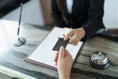 Premium Photo Hotel Receptionist In Uniforms Concierge Giving The Key