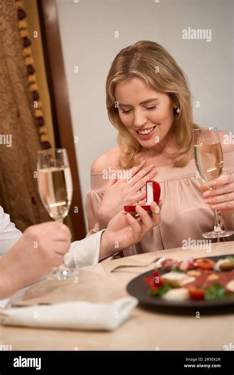 Woman Getting Marriage Proposal From Handsome Man At Table In