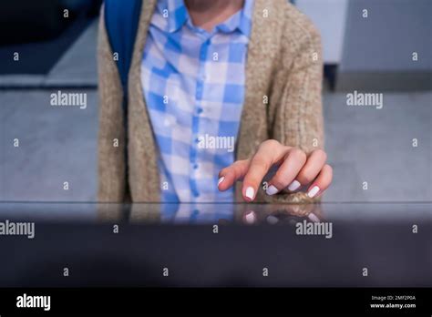 Woman Using Interactive Touchscreen Display At Modern Museum Or