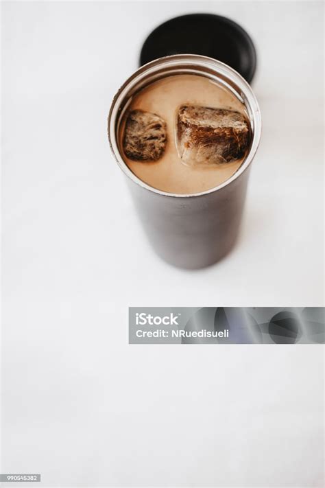 가 서 아이스 커피입니다 우유 부 어 보온병에 커피 얼음 큐브를 동결 보온병 뚜껑 병 근처입니다 흰색 배경입니다 절연 공간에