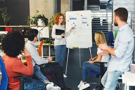 premium photo a group of diverse individuals sitting around a whiteboard in a meeting room