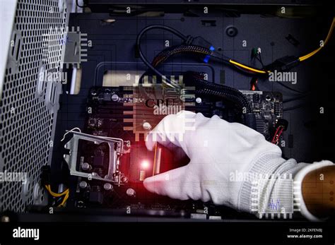 Image Of A Technician Inserting A Cpu Chip Onto A Computer Motherboard