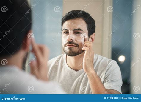 Young Man Applying Anti Aging Lotion Fot Skin Care Stock Image Image