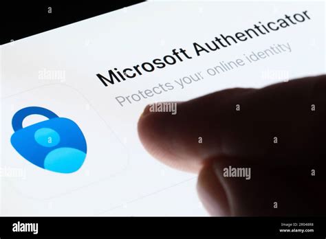 Microsoft Authenticator App Seen In App Store On The Screen Of Ipad And Blurred Finger Pointing