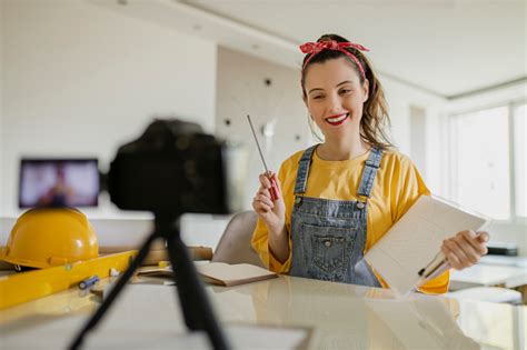 Beautiful Female Engineer Filming Tutorial And Working From Home Stock