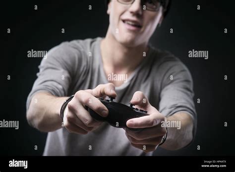 Smiling Nerd Teenager Holding Video Game Controller And Playing Stock Photo Alamy
