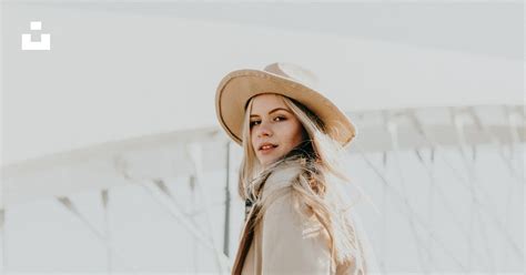 갈색 코트를 입은 여자 갈색 모자를 쓰고 낮에 눈 덮인 땅에 서 있다 사진 Unsplash의 무료 회색 이미지