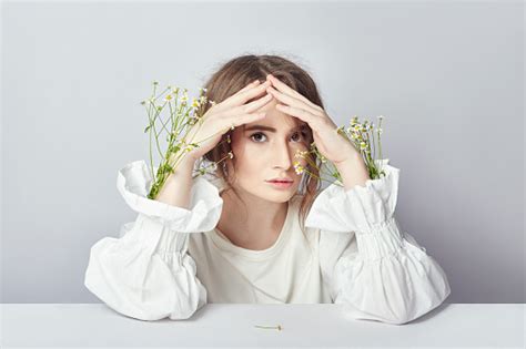 곱슬 금발 낭만적 인 모습 아름 다운 눈 손에 흰 야생화 소녀 흰 빛 드레스와 곱슬 머리 흰색 배경 순도와 무죄에 꽃을 가진 여자의 초상화 가정 생활에 대한 스톡 사진 및