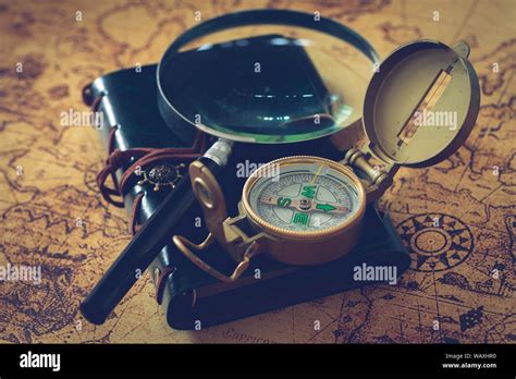Old Map With Compass Notebook And Magnifying Glass The Concept Of