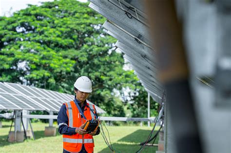 Engineers Are Checking The Solar Panels With A Performance Checker To Verify That Each Solar