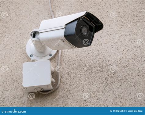 Close Up Surveillance Cctv Camera On Gate Of Construction Site People With Flare Light Effect