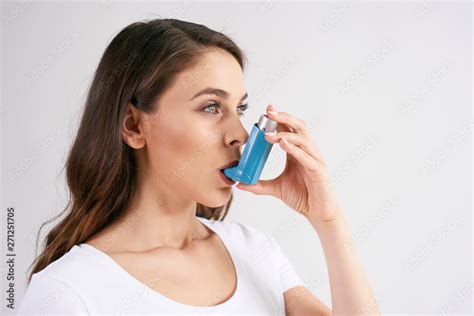 Asthmatic Woman Using An Asthma Inhaler During Asthma Attacks Stock