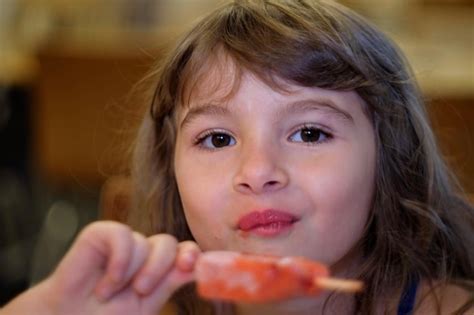 Premium Photo Portrait Of Of Girl Eating Popsicle