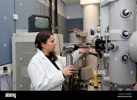Transmission Electron Microscopy Scientist Introducing A Specimen Into A Transmission Electron