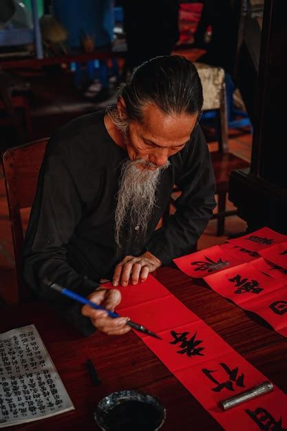 Premium Photo Vietnamese Scholar Writes Calligraphy At Long Son Calligraphy Festival Is A