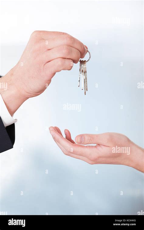Consultant Giving Keys To Woman In Office Stock Photo Alamy