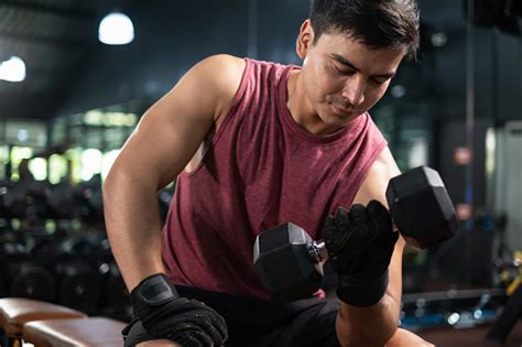 코 카 서 스 남성 또는 운동 선수 앉아 하 고 피트 니스 체육관에서 운동 이두근에 대 한 한 손으로 아령을 리프팅 코치와 보디 훈련 운동 라이프 스타일과 건강한 개념 팔