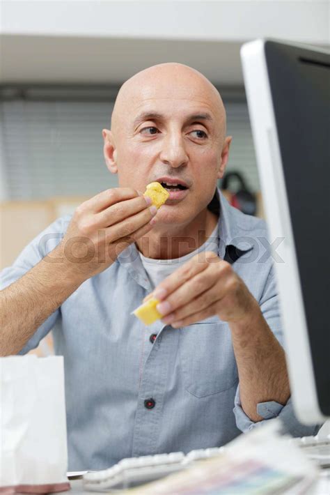 Man Eating Chips In Front Of Computer Stock Image Colourbox