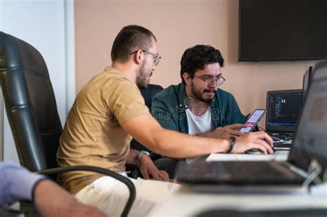 Collaborative Minds A Team Of Programmers Tackling Challenges Together In The Office Stock