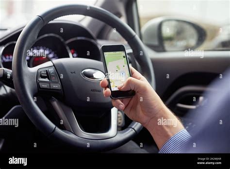 Let Your GPS Guide You Closeup Shot Of A Driver In A Car Using A Cellphone To Find Directions