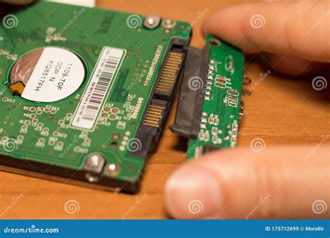 Close Up View Of Hands Connecting An Internal Hard Drive Of A Notebook To An External Usb Box
