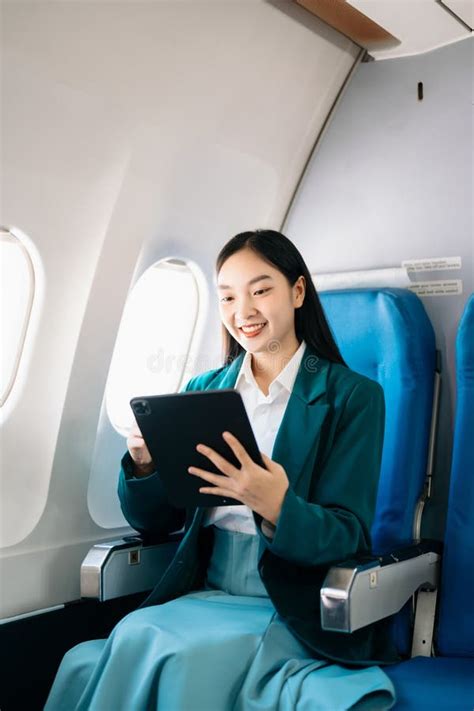 Young Asian Executive Excels In First Class Multitasking With Digital
