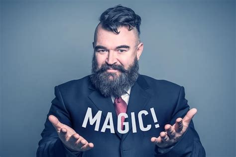 Premium Photo Adult Bearded Man In A Suit Holding The Inscription Magic