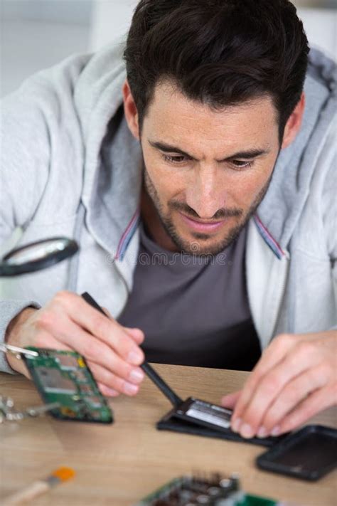 Young Energetic Male Tech Or Engineer Repairs Electronic Equipment Stock Image Image Of Brown