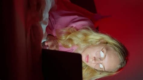 Programmer Woman In Glasses Lying In Bed Working On A Laptop It