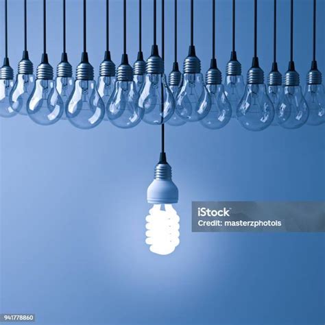 한 친환경 에너지 절약 전구 빛나는 거 고 어두운 파란색 배경 리더십 및 다른 창조적인 아이디어 개념에 Unlit 백열 전구에서 밖으로 서 있는 0명에 대한 스톡 사진 및