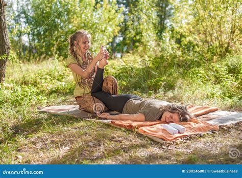Massage Girl Performs A Relaxing Massage In The Forest Stock Image