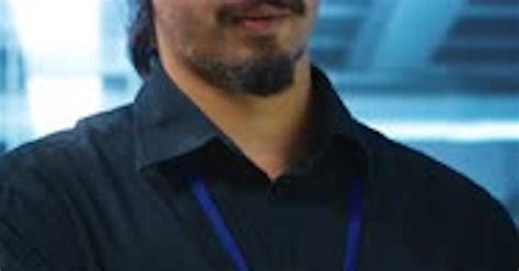 Vertical Video Manager In Data Center Doing Annual System Review Checking Parameters On Laptop