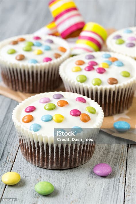 화이트 아이싱과 컬러 스마티스를 곁들인 초콜릿 컵케이크 머핀에 대한 스톡 사진 및 기타 이미지 머핀 공휴일 노랑 Istock