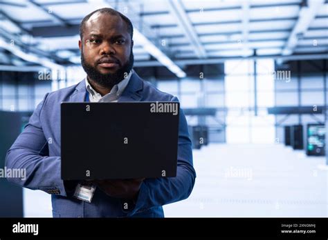 Programmer In Data Center Using Laptop To Identify And Solve Technical Issues Related To Data
