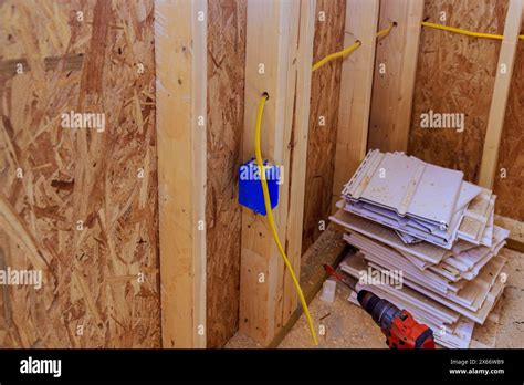 An Electrician Installs Assembled Electrical Wires On An Interior In Construction Site Stock